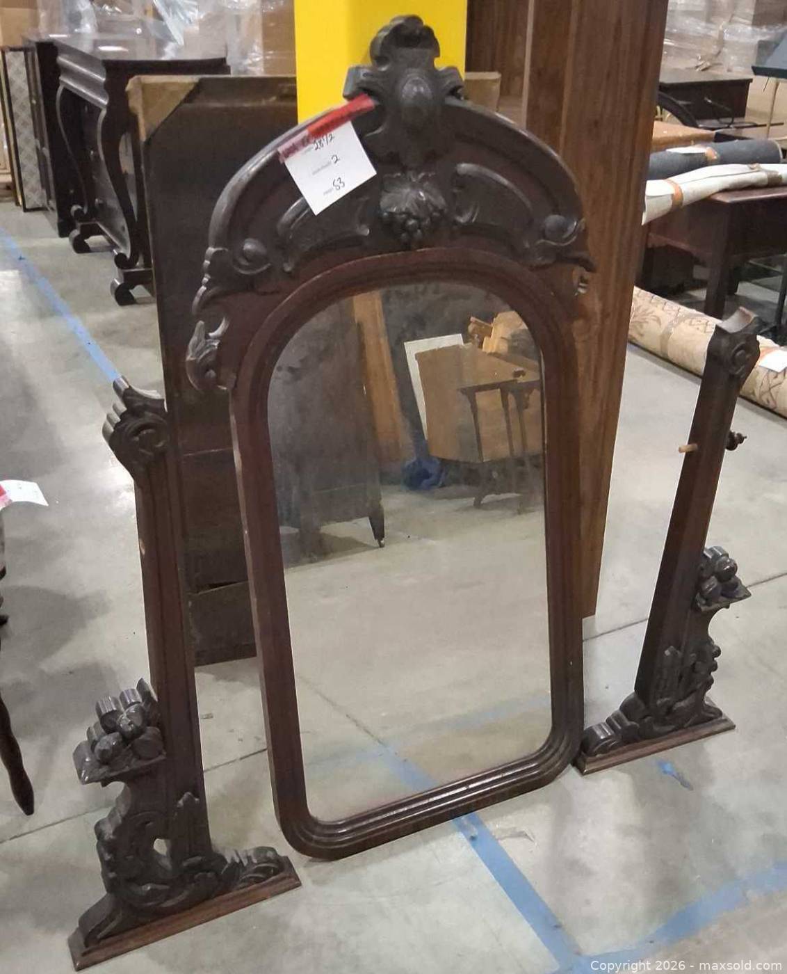 Ornate carved wooden mirror with side supports | Maxsold