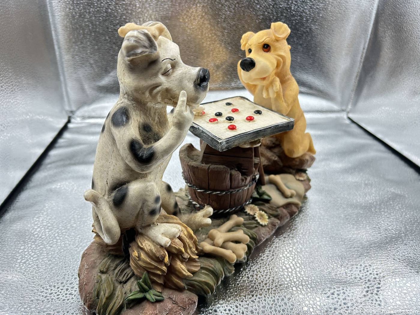 Hollow ceramic figurine dogs playing checkers | Maxsold