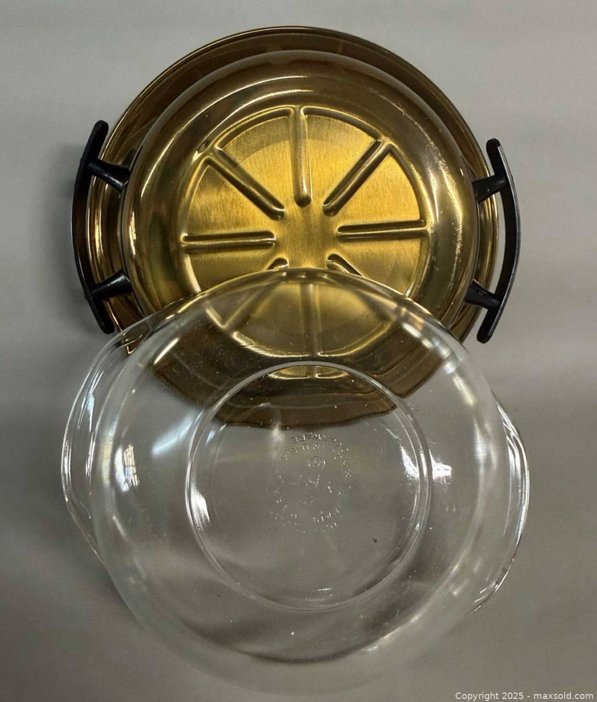 Pyrex glass casserole with gold-tone aluminum holder and lid | Maxsold