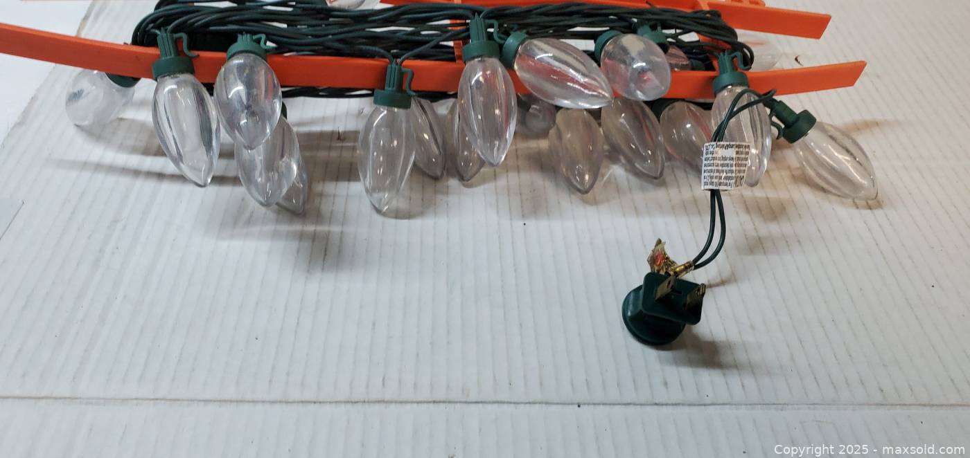 Clear C7 Christmas light strand with orange storage holder | Maxsold