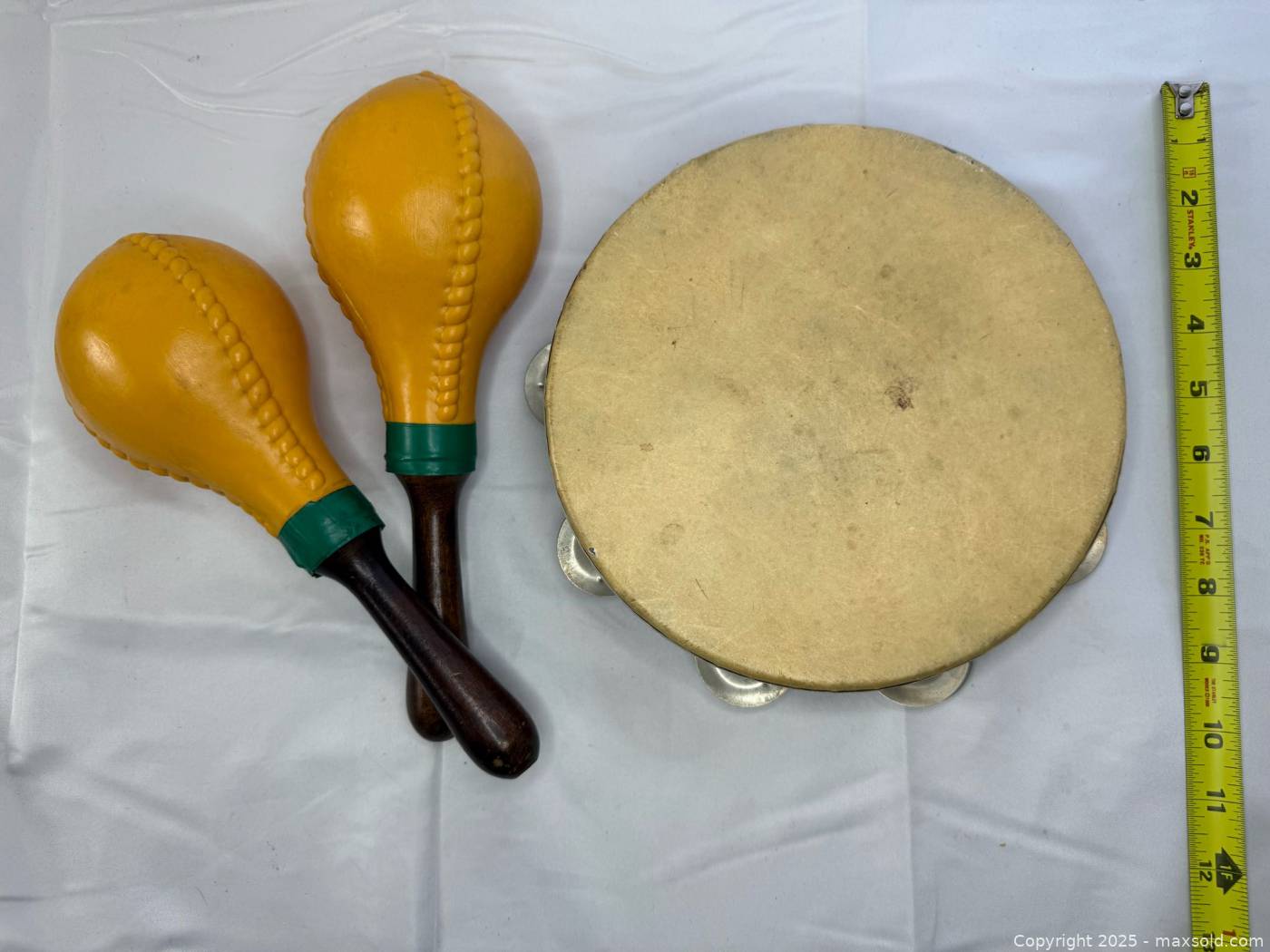 Pair of yellow maracas with green collars and wood handles plus skin ...