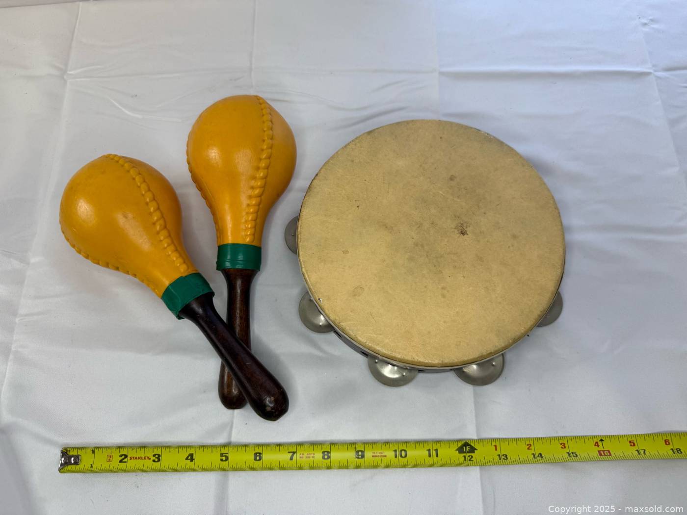 Pair of yellow maracas with green collars and wood handles plus skin ...