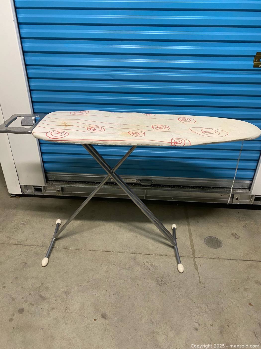 Folding metal-frame ironing board with iron rest | Maxsold