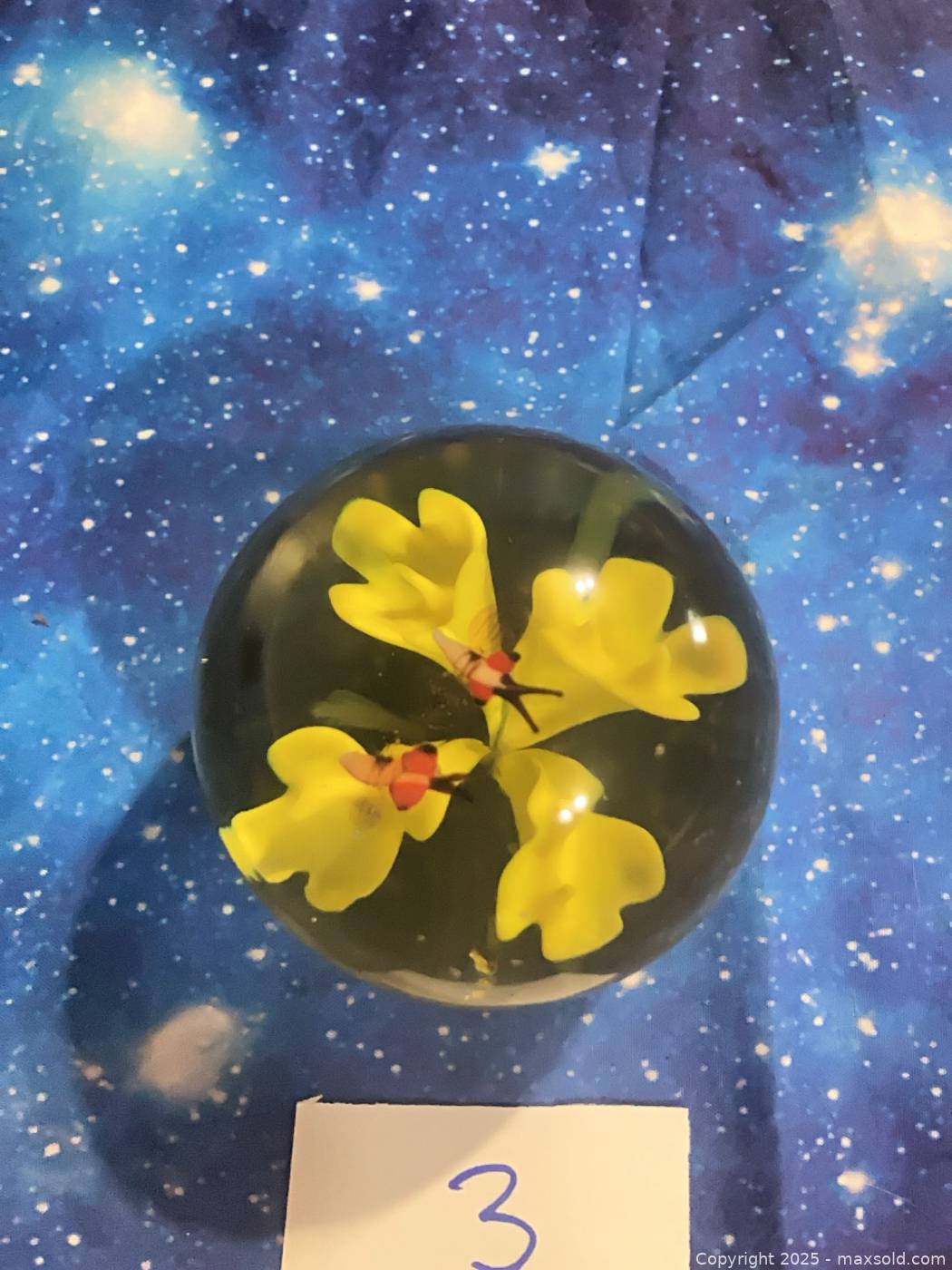 Glass sphere paperweight with yellow flower | Maxsold