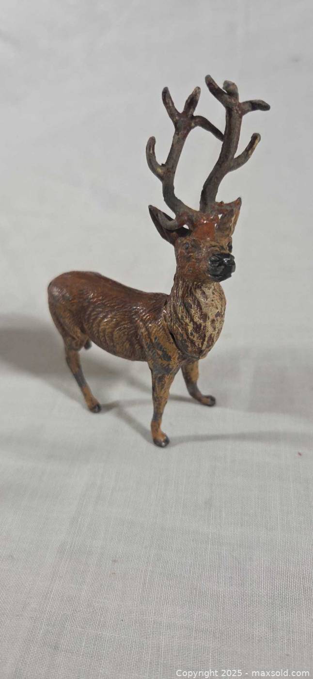 Four antique German metal reindeer figurines | Maxsold