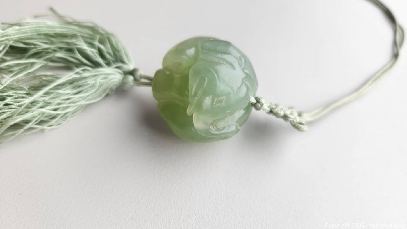 Carved green jade ball elephant pendant | Maxsold