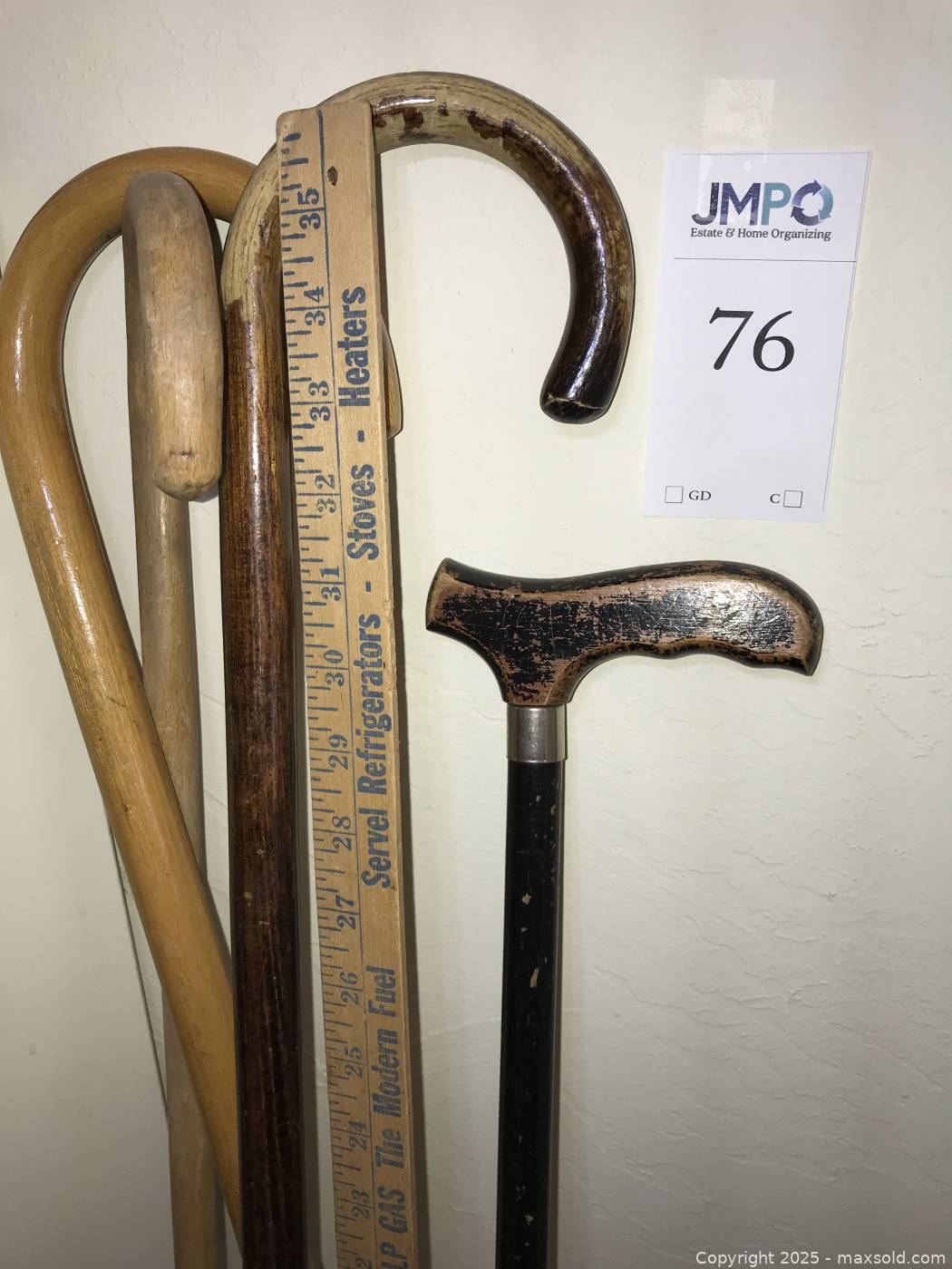 Four assorted wooden walking canes | Maxsold