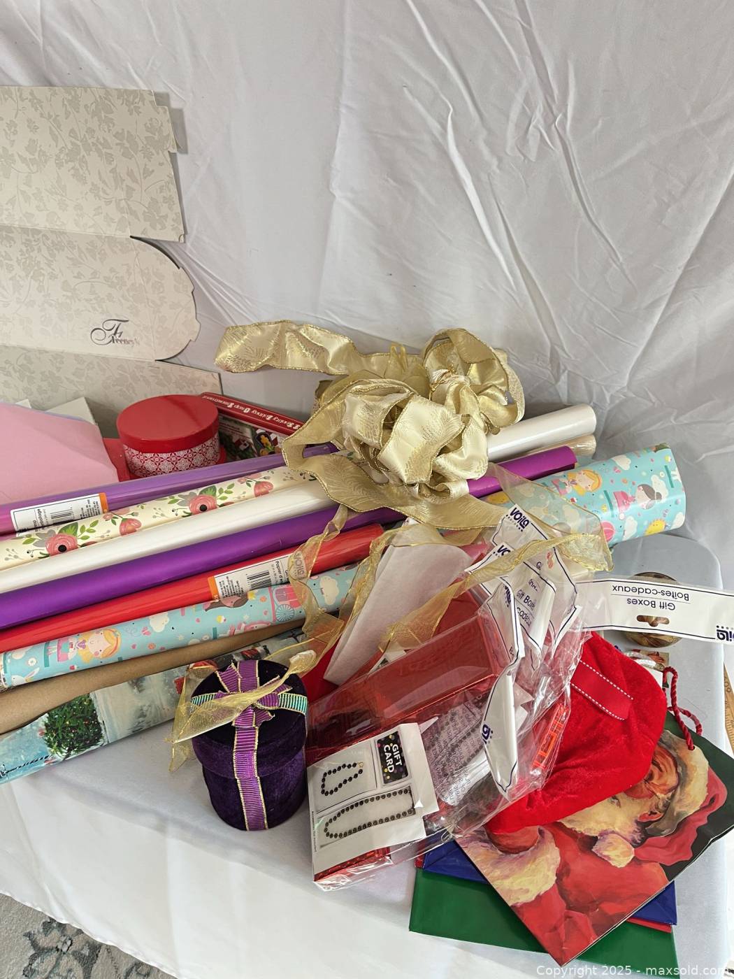 Assorted gift wrap rolls, tissue, ribbons, boxes, bags | Maxsold