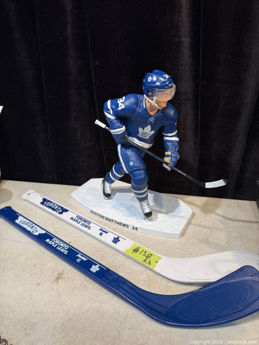 Auston Matthews figurine with two mini Toronto Maple Leafs sticks | Maxsold