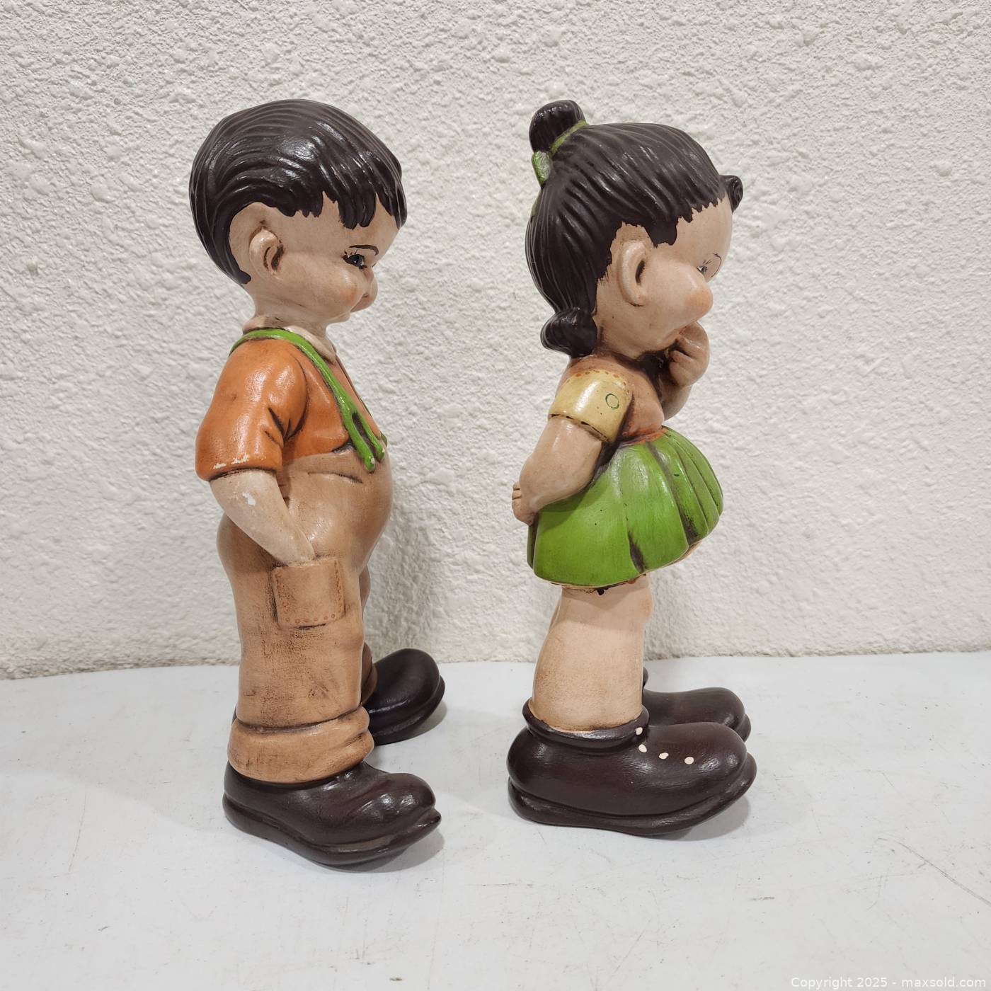 Pair of vintage hand-painted boy and girl ceramic figurines | Maxsold