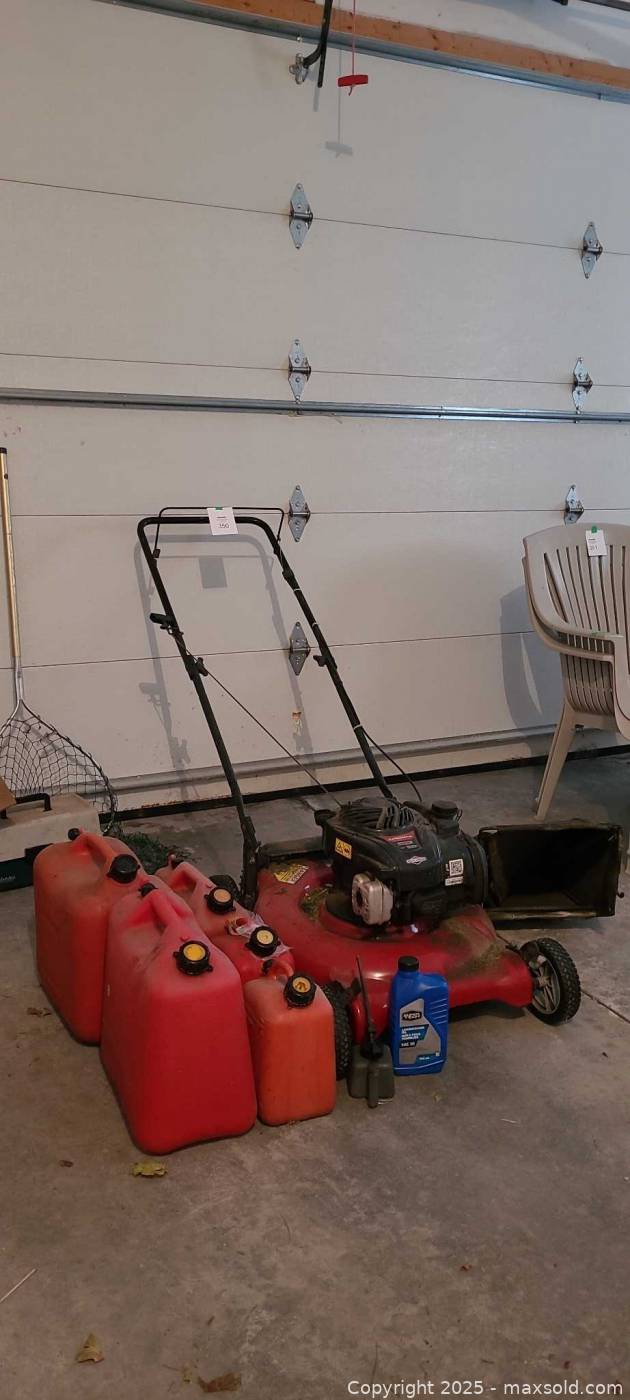 Canadiana push lawn mower with gas cans | Maxsold
