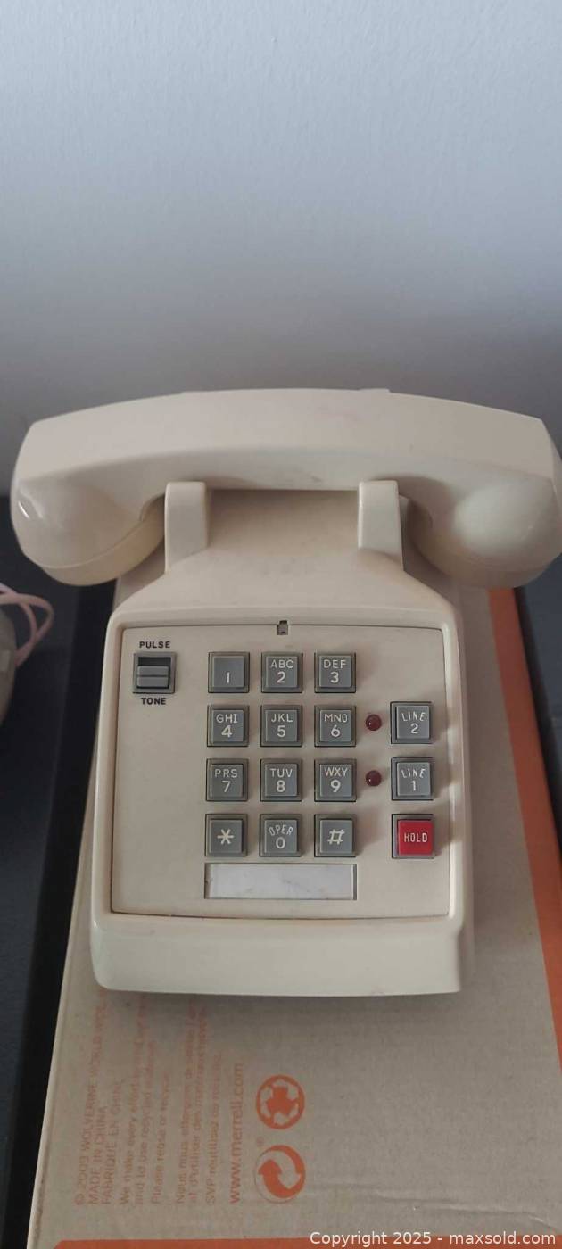 Vintage corded push-button landline telephone and electronic calculator ...