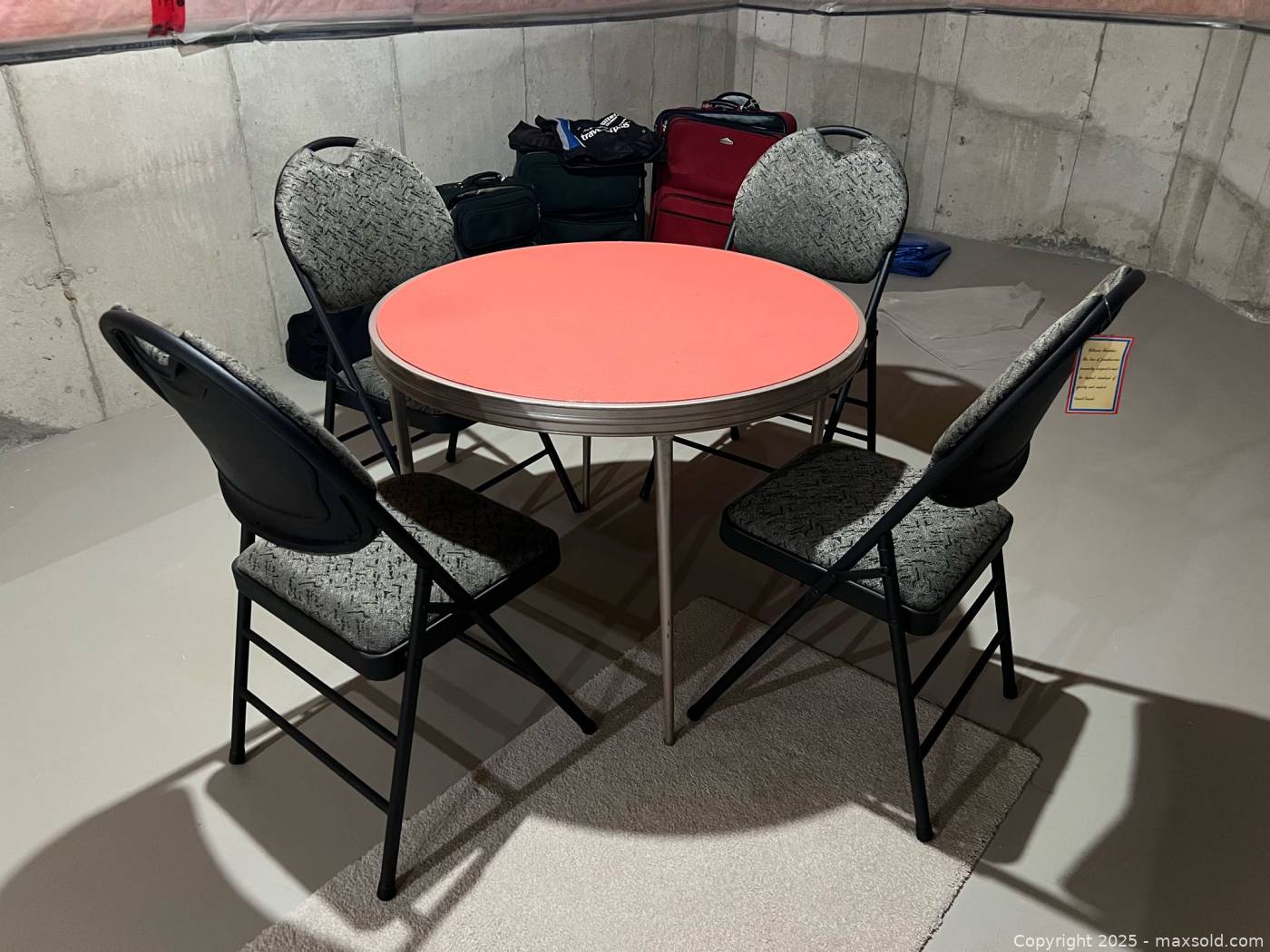 Cooey round folding card table with four metal folding chairs | Maxsold