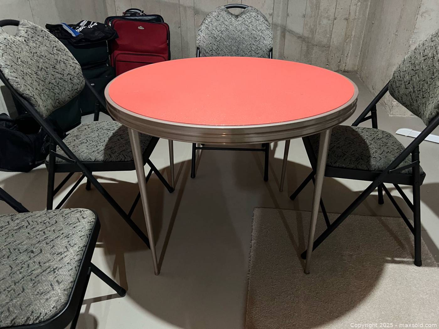 Cooey round folding card table with four metal folding chairs | Maxsold