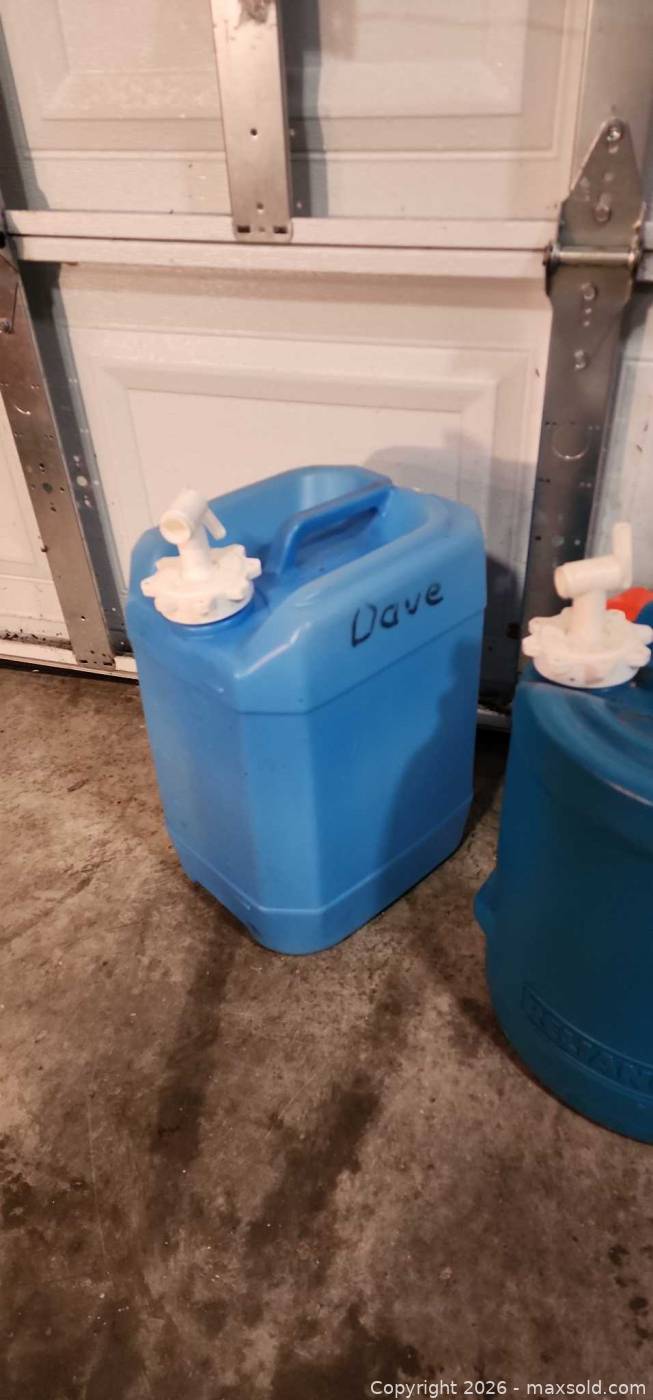 Two blue water transport containers with spigots | Maxsold