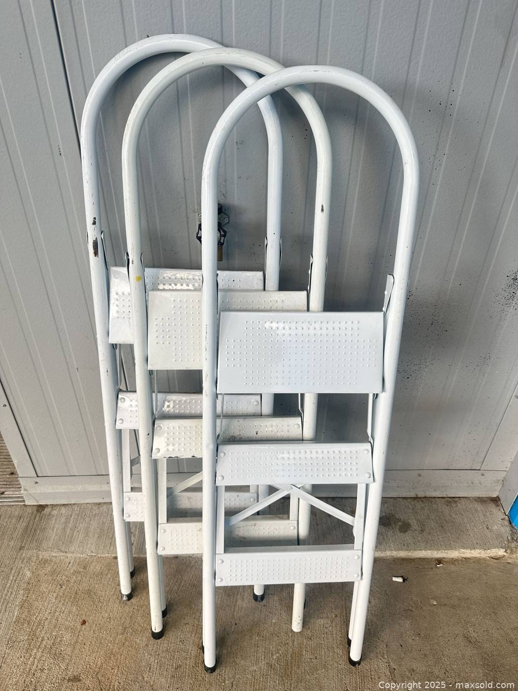 Two white folding steel step ladders | Maxsold