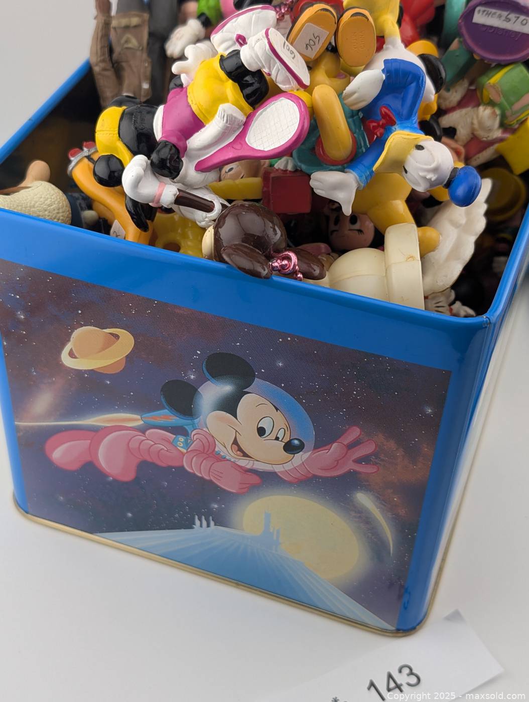 Disney metal tin with ~60 mini character figurines | Maxsold