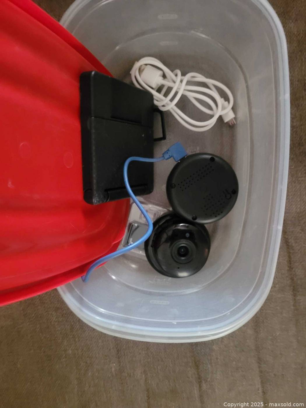 Two black covert security cameras with USB cables, charger and storage ...