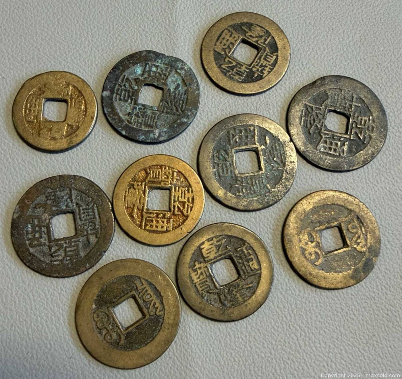 10 Chinese cash coins and 2 spade coins | Maxsold