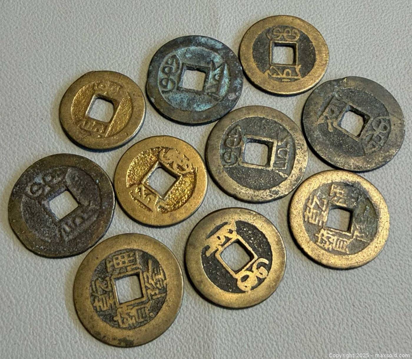 10 Chinese cash coins and 2 spade coins | Maxsold