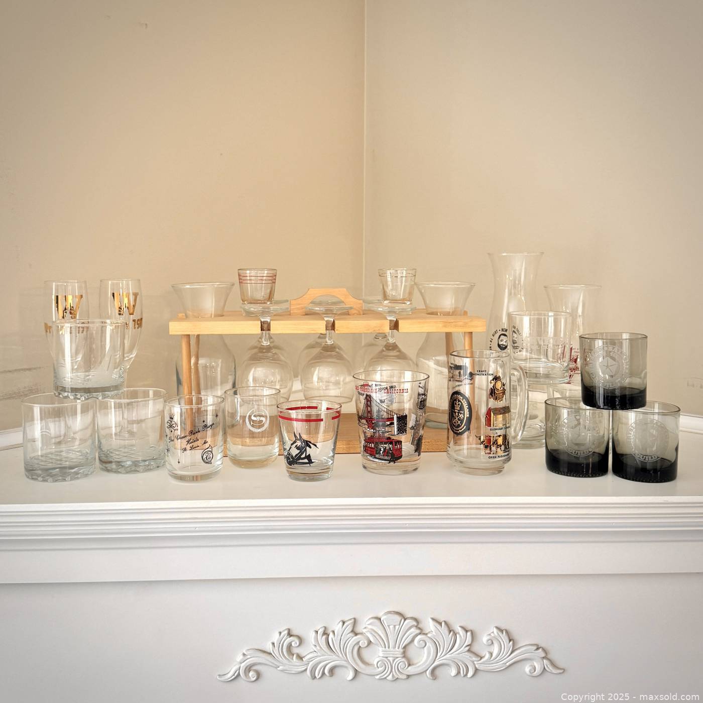 Assorted bar glassware and wooden wine rack | Maxsold
