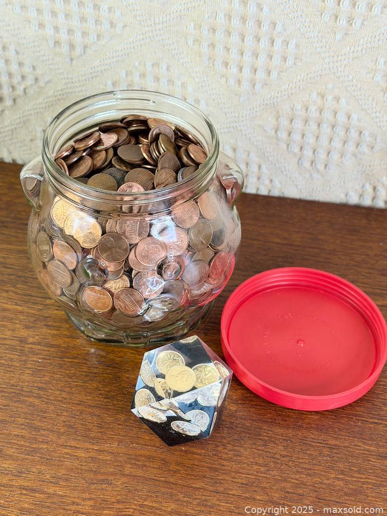 Jar of Canadian and U.S. Pennies and Lucite Coin Paperweight | Maxsold
