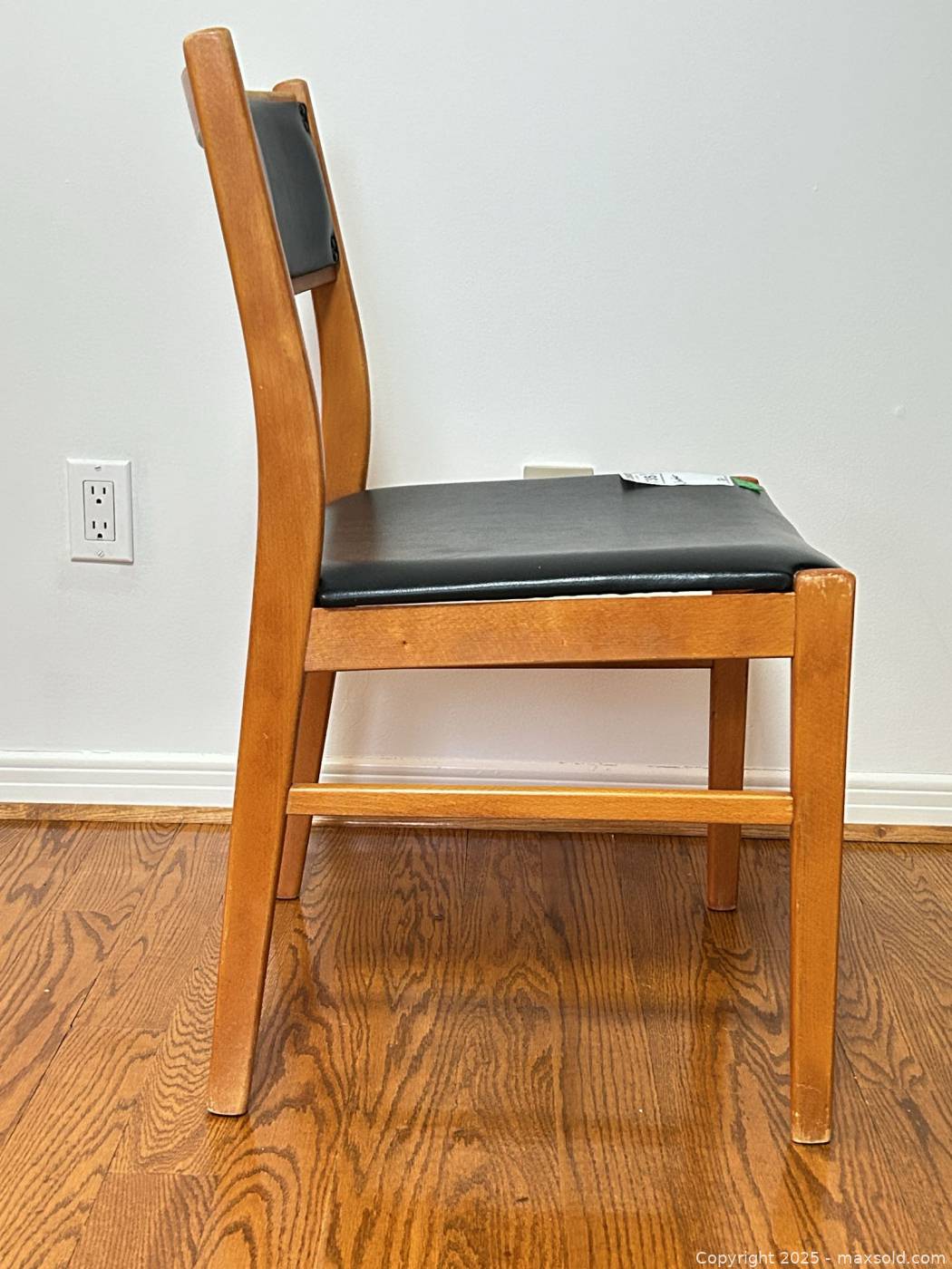 Wood frame chair with black faux leather seat and back | Maxsold