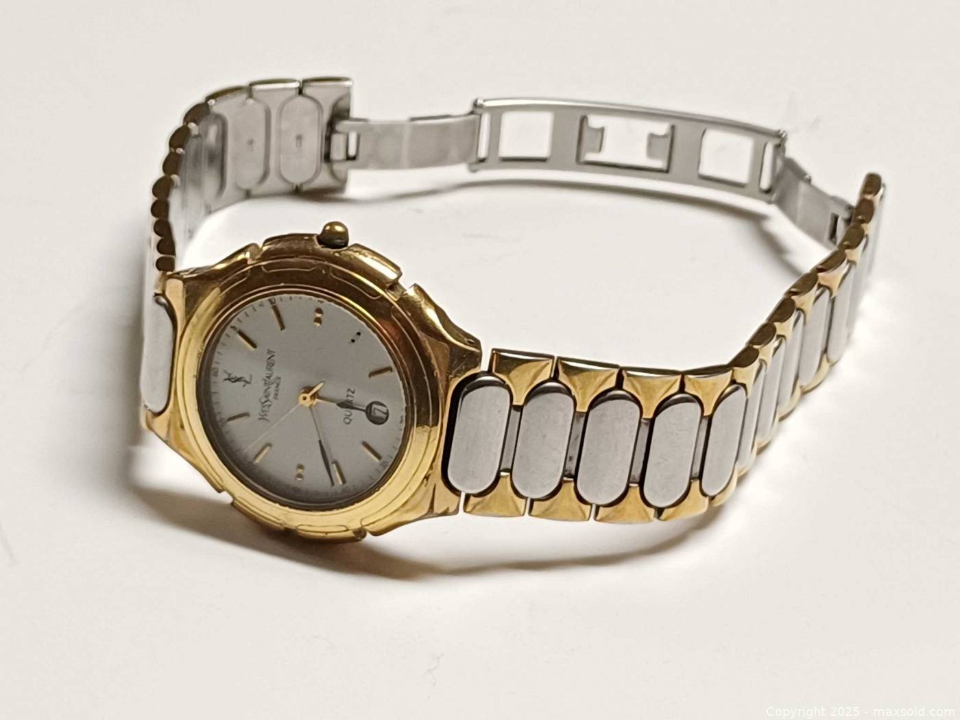 Yves Saint Laurent gold bezel quartz watch | Maxsold