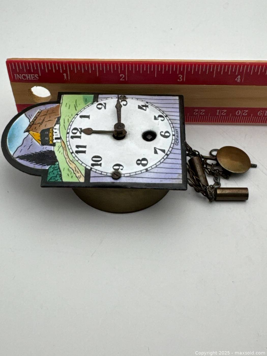 Miniature German brass enamel cuckoo-style wall clock | Maxsold