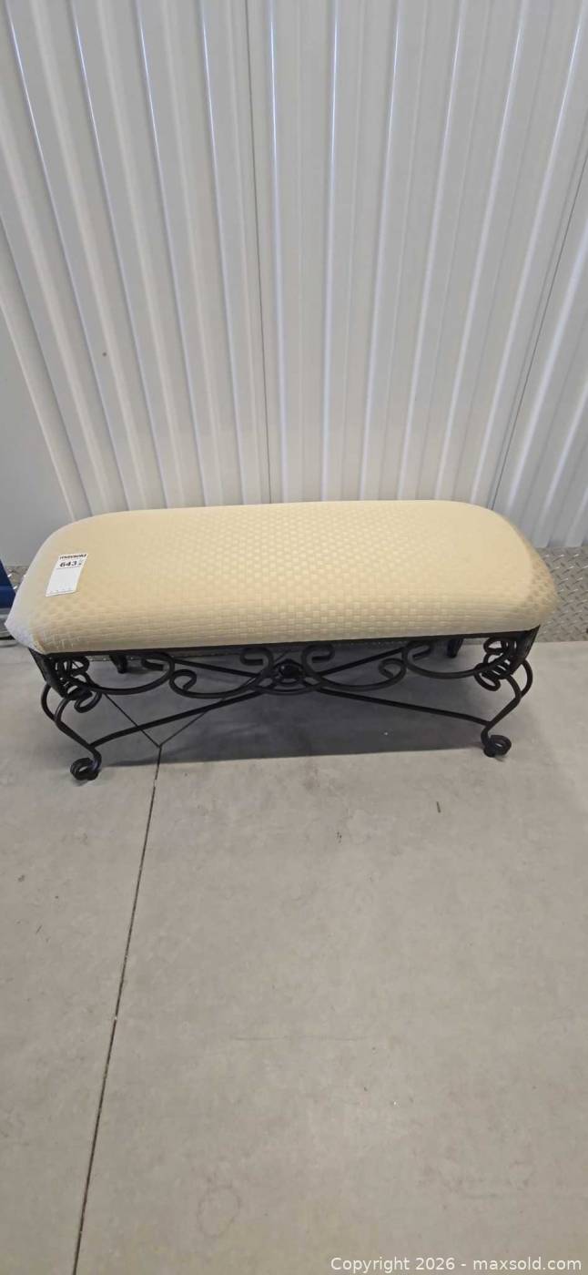 ornate metal bench with upholstered cushion | Maxsold