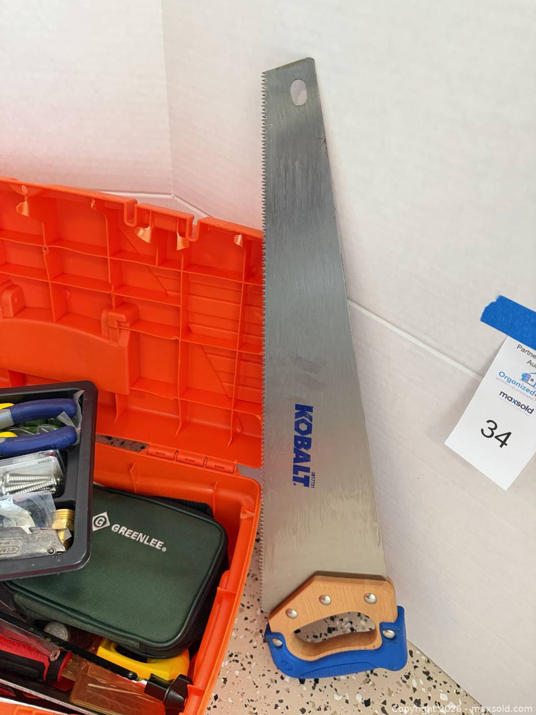 Mixed plumbing and electrical hand tools in orange plastic toolbox ...