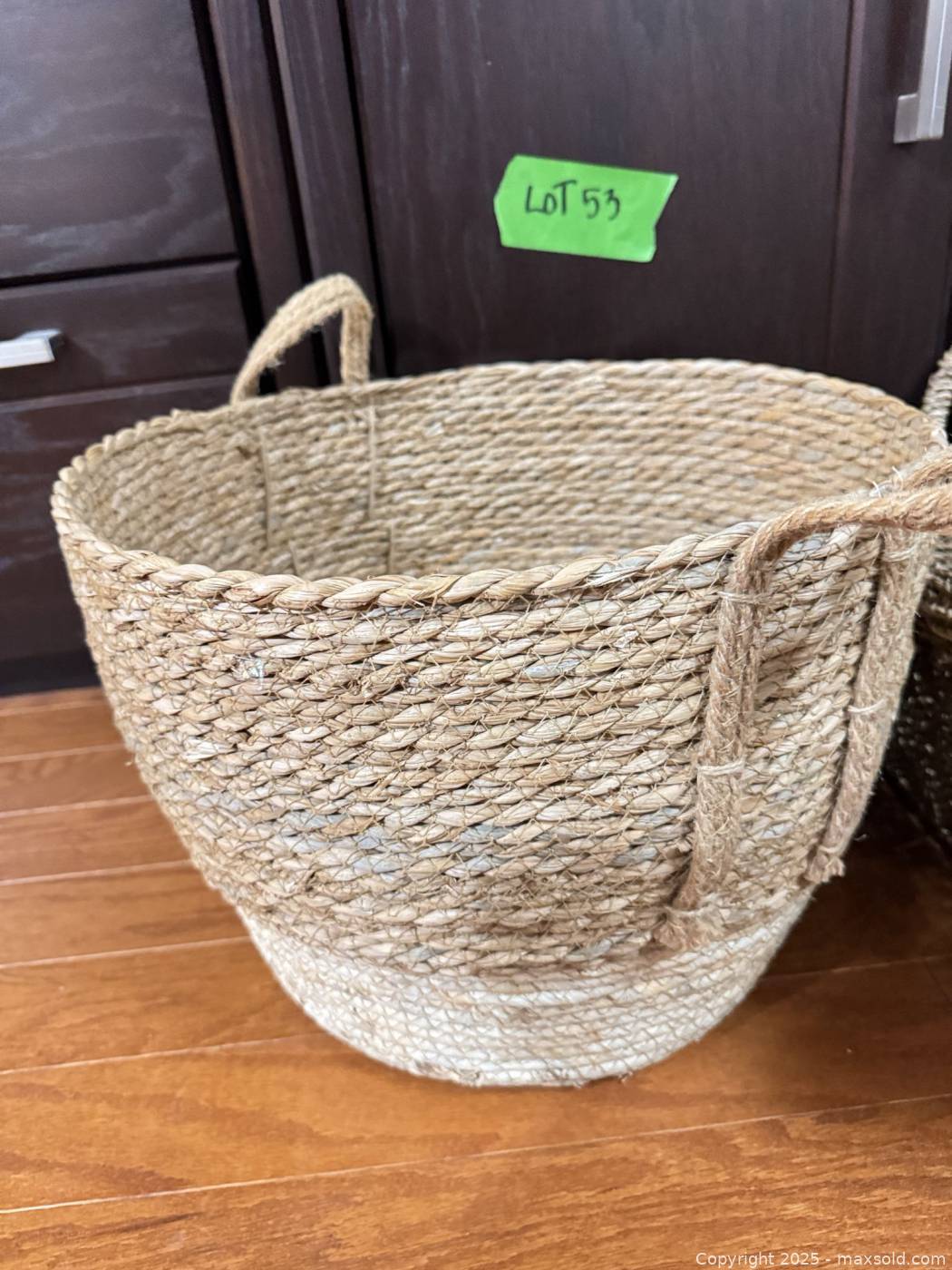 Two natural woven storage baskets with handles | Maxsold