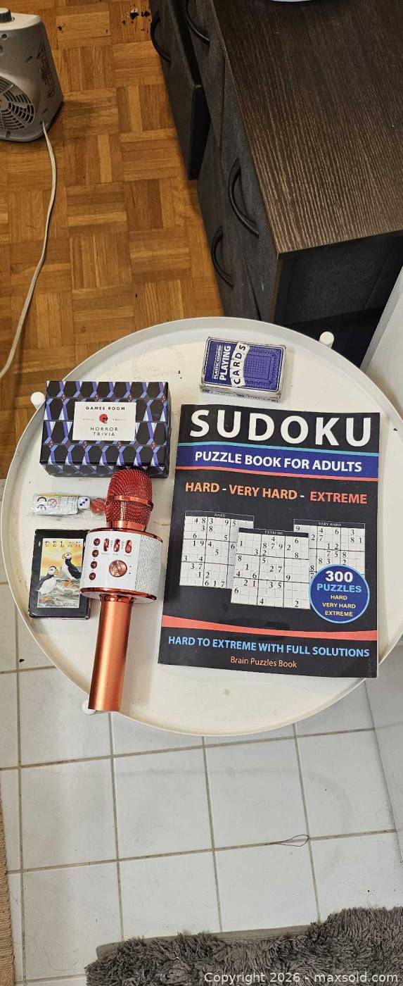 Sudoku book, wireless karaoke mic, cards, small game lot | Maxsold