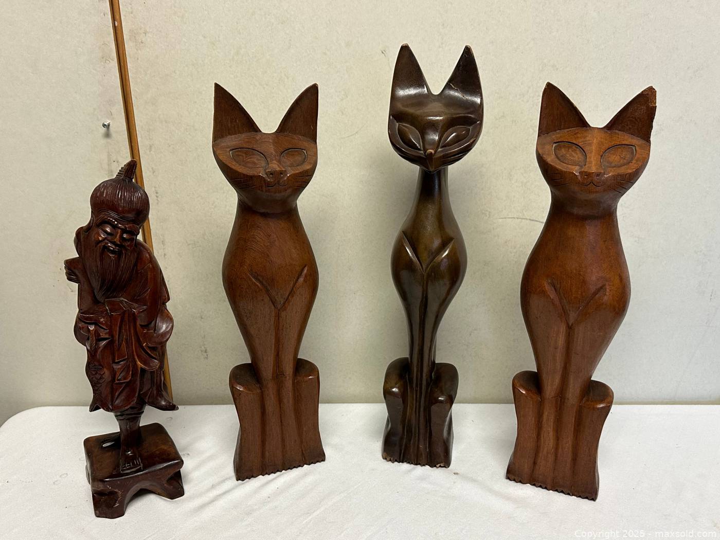 Four carved wooden cat and Asian elder statues | Maxsold