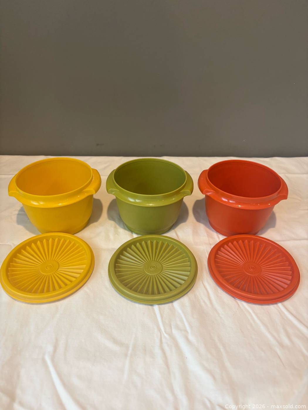 3 small round Tupperware containers with lids | Maxsold