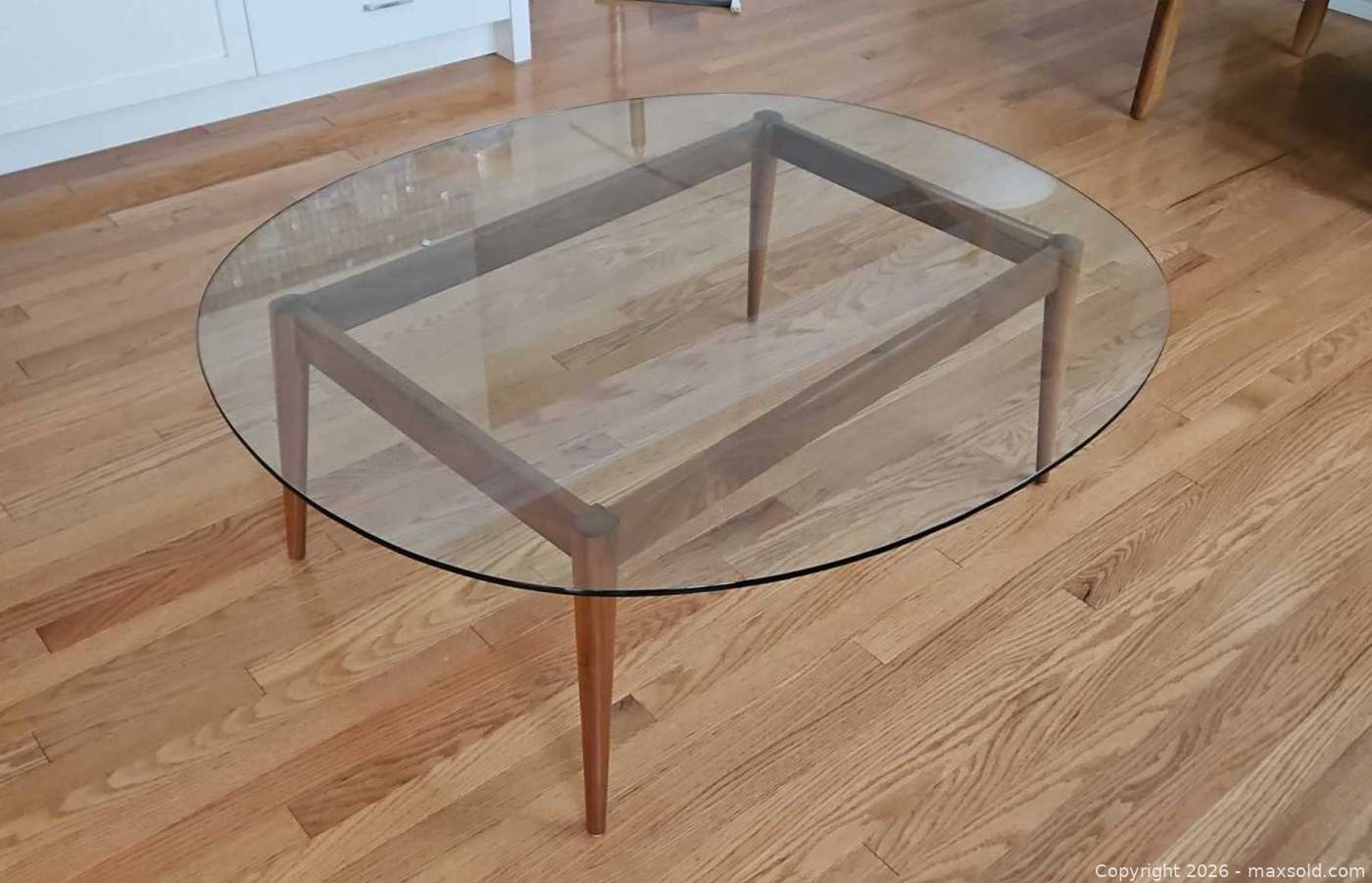 De Gaspe oval glass coffee table | Maxsold