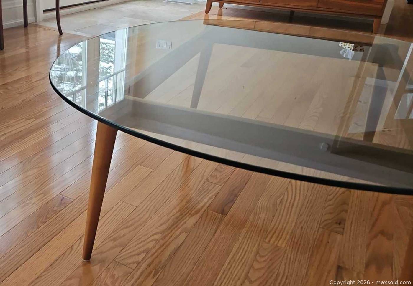 De Gaspe oval glass coffee table | Maxsold