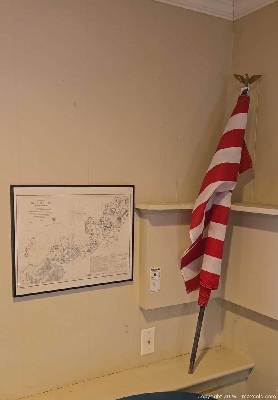 Framed nautical chart and American flag with pole and eagle finial ...
