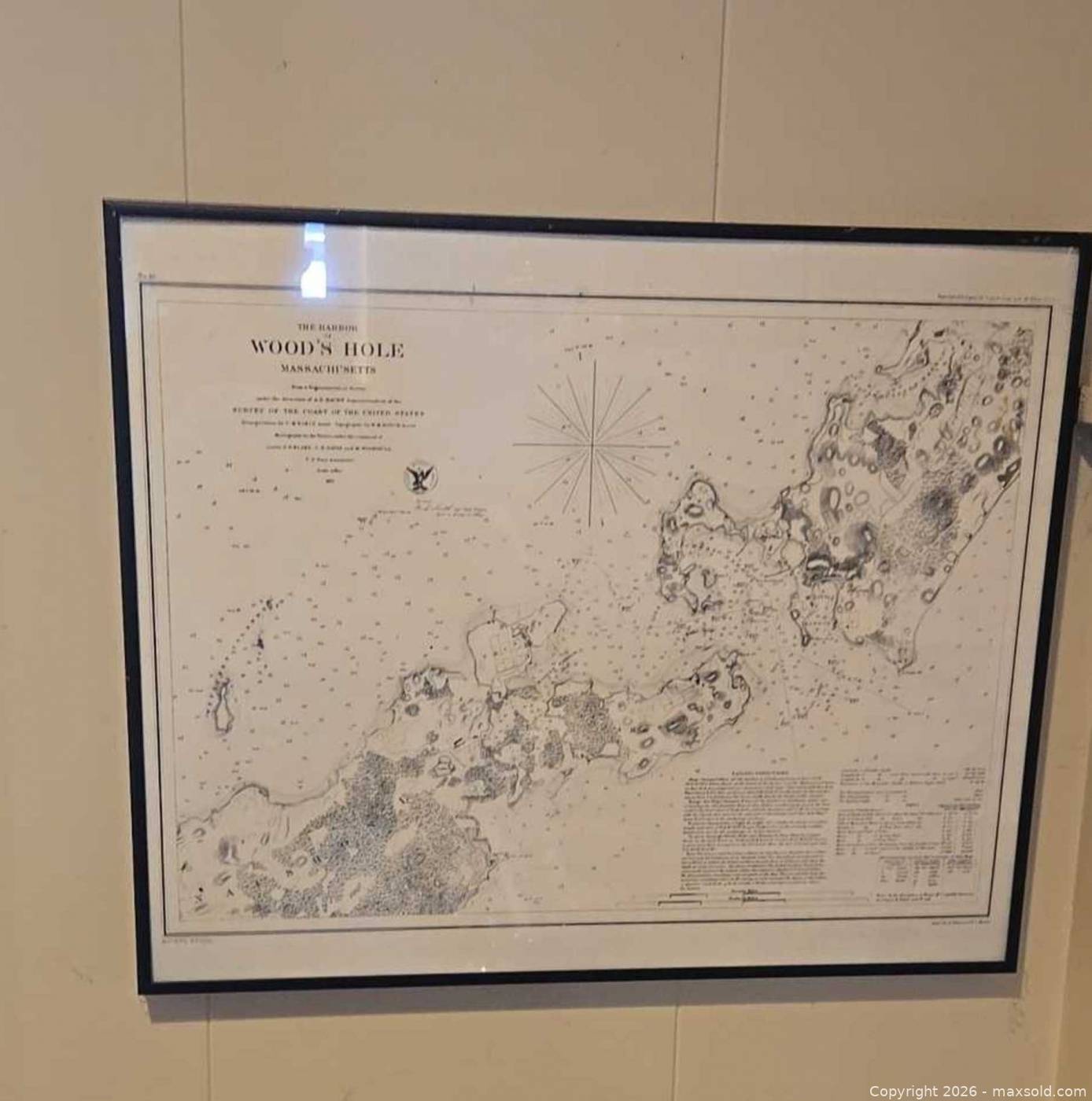 Framed nautical chart and American flag with pole and eagle finial ...