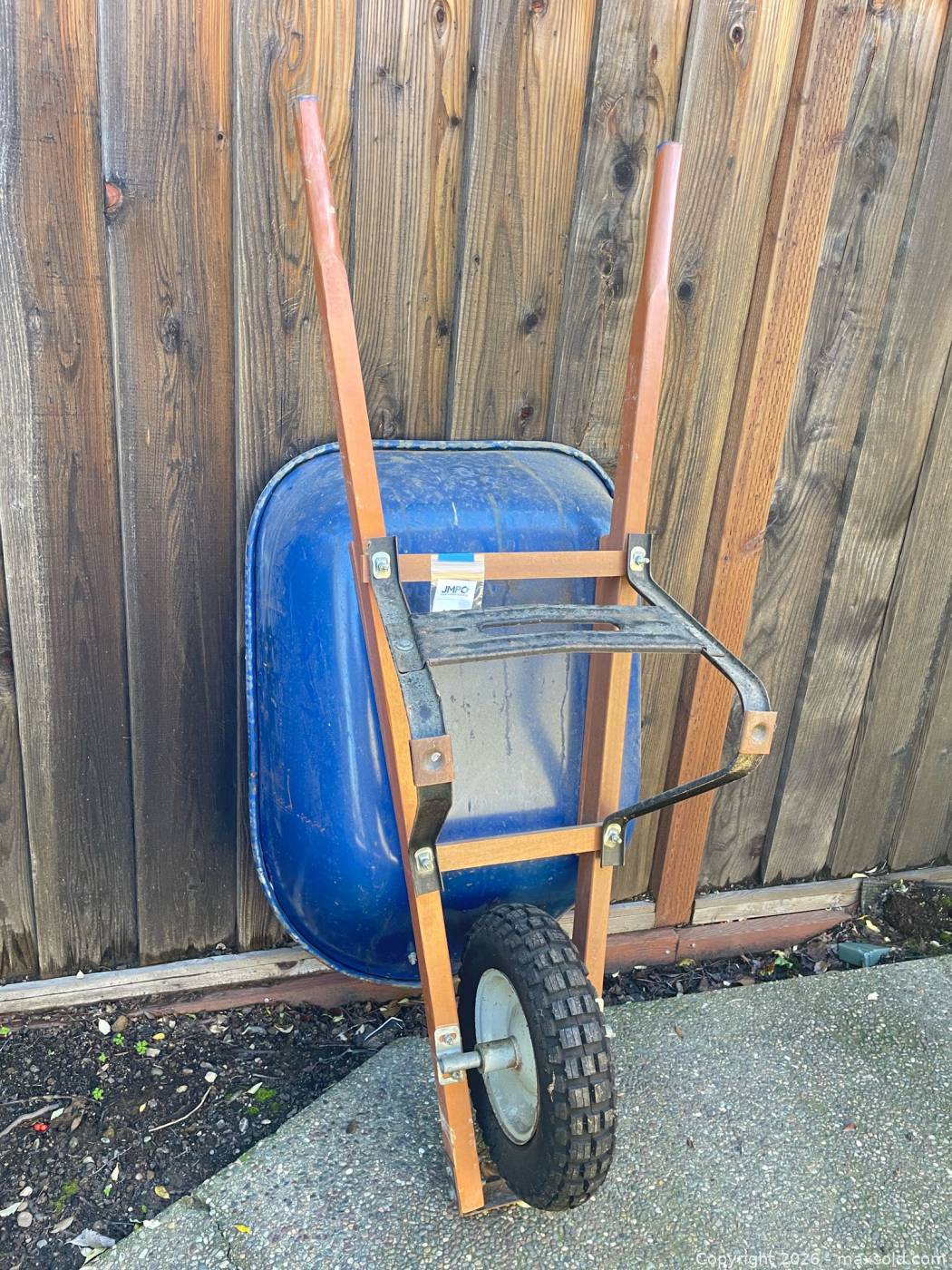 Blue metal wheelbarrow with wooden handles | Maxsold
