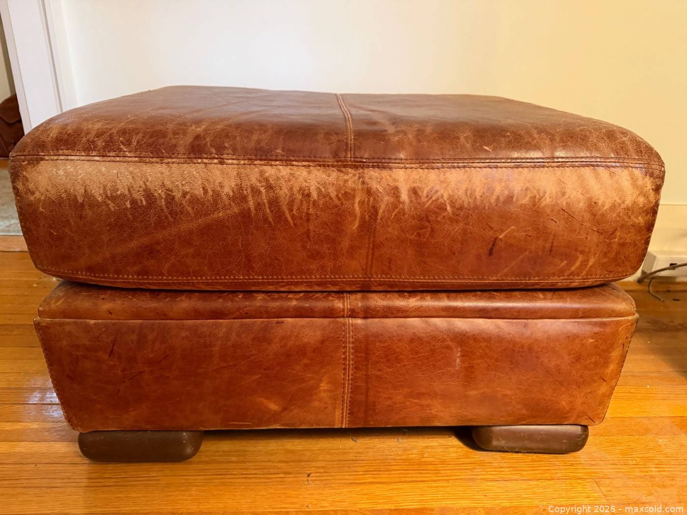 Cognac leather ottoman, 27.5x21x23 in | Maxsold