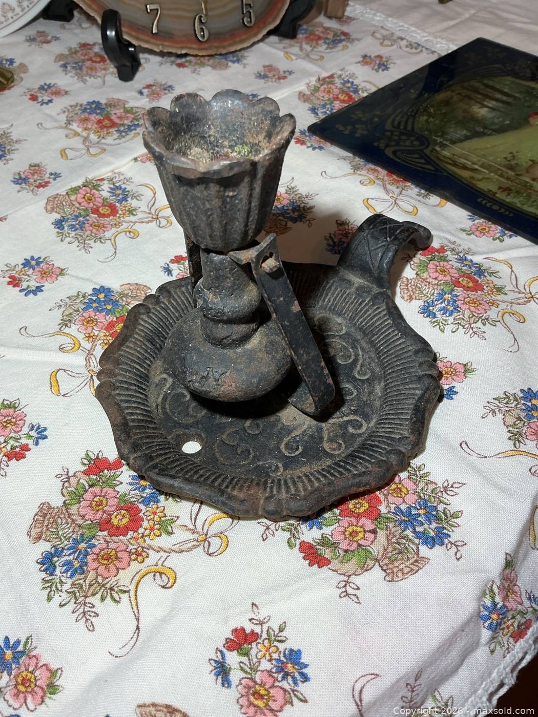 Cast iron chamberstick and 6x9 glass picture | Maxsold