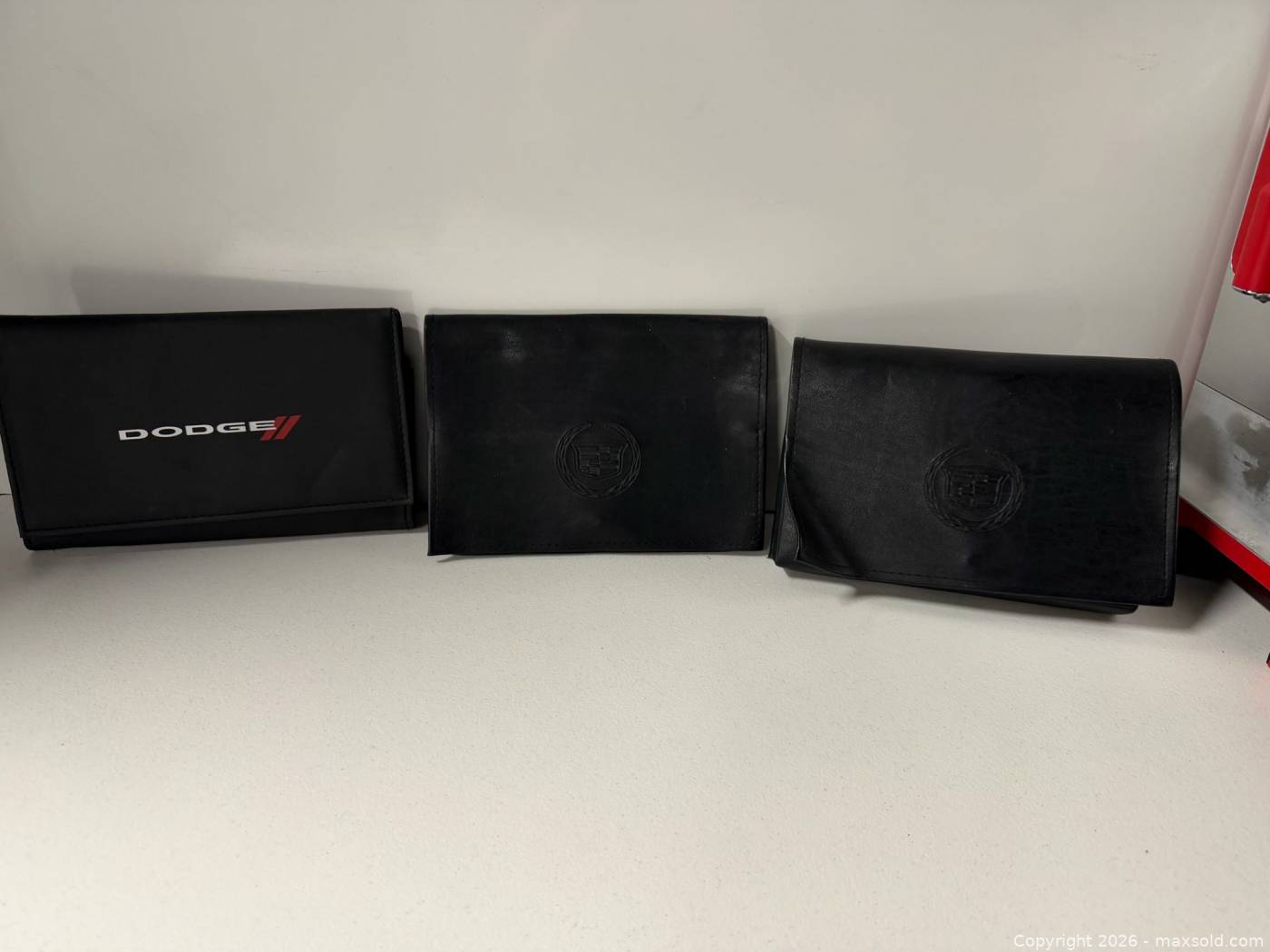 Cadillac and Dodge document wallets | Maxsold