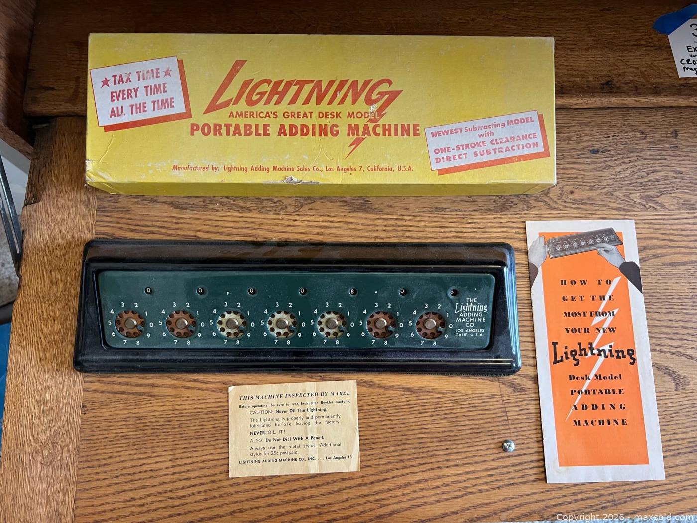 Lightning portable adding machine with box | Maxsold