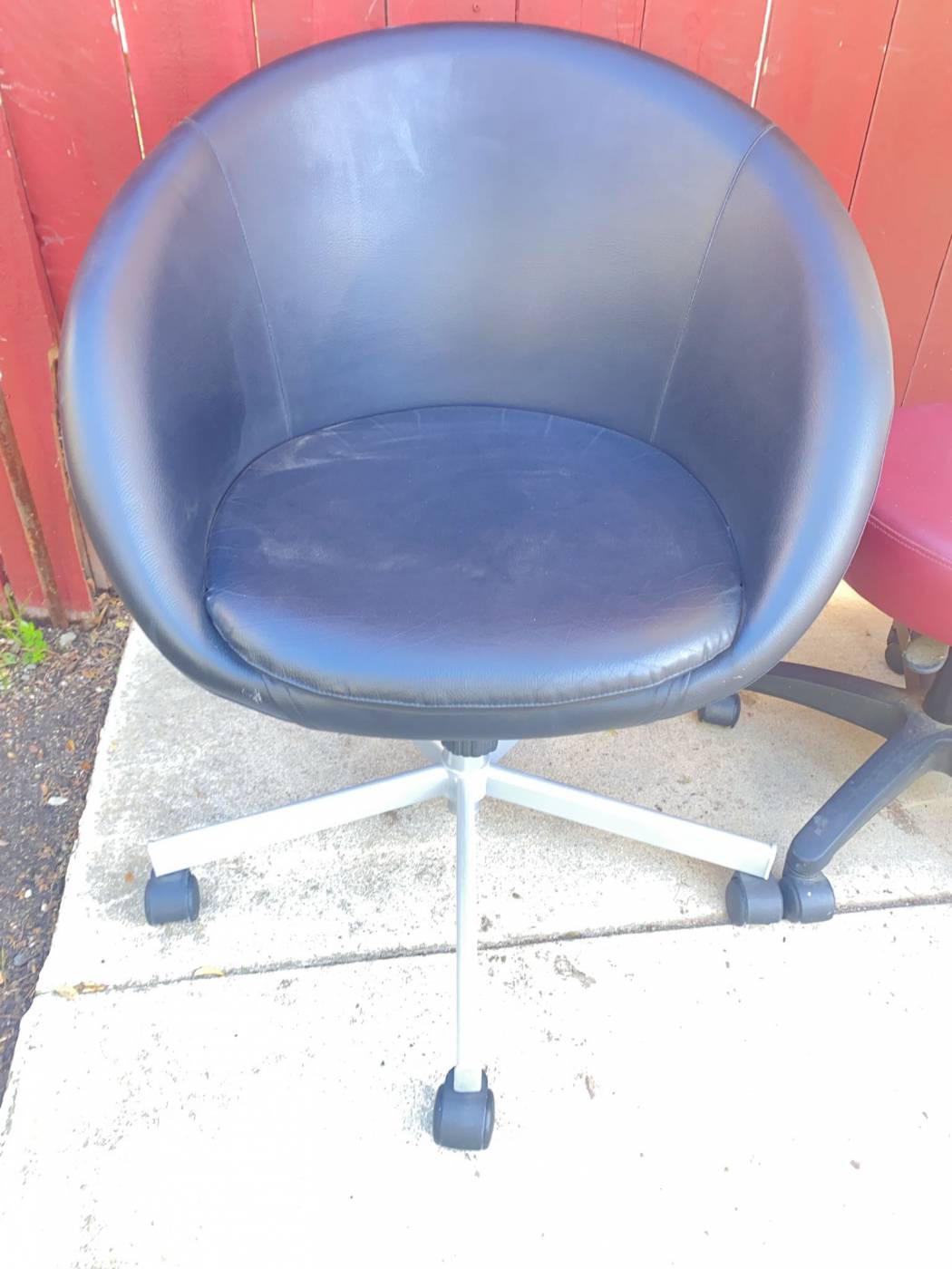 Black rolling vinyl tub chair with casters and maroon vinyl round ...