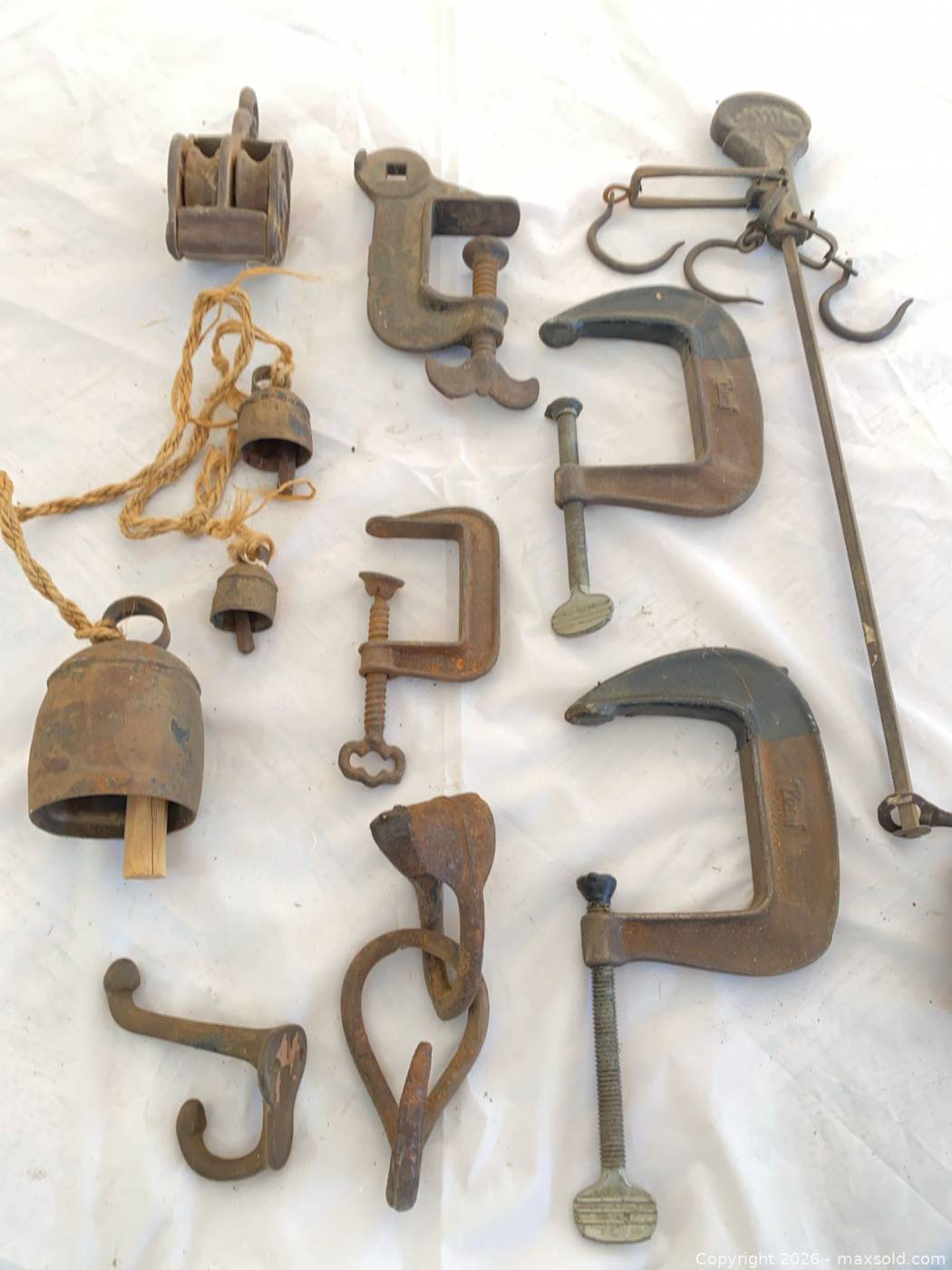 Vintage cast iron scale, clamps, bells | Maxsold