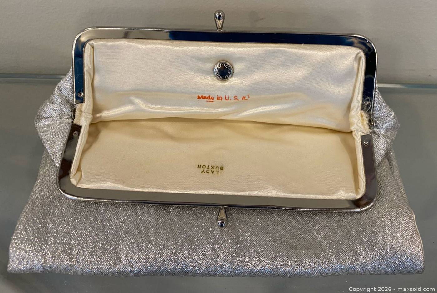 Lady Buxton metallic silver clutch bag | Maxsold