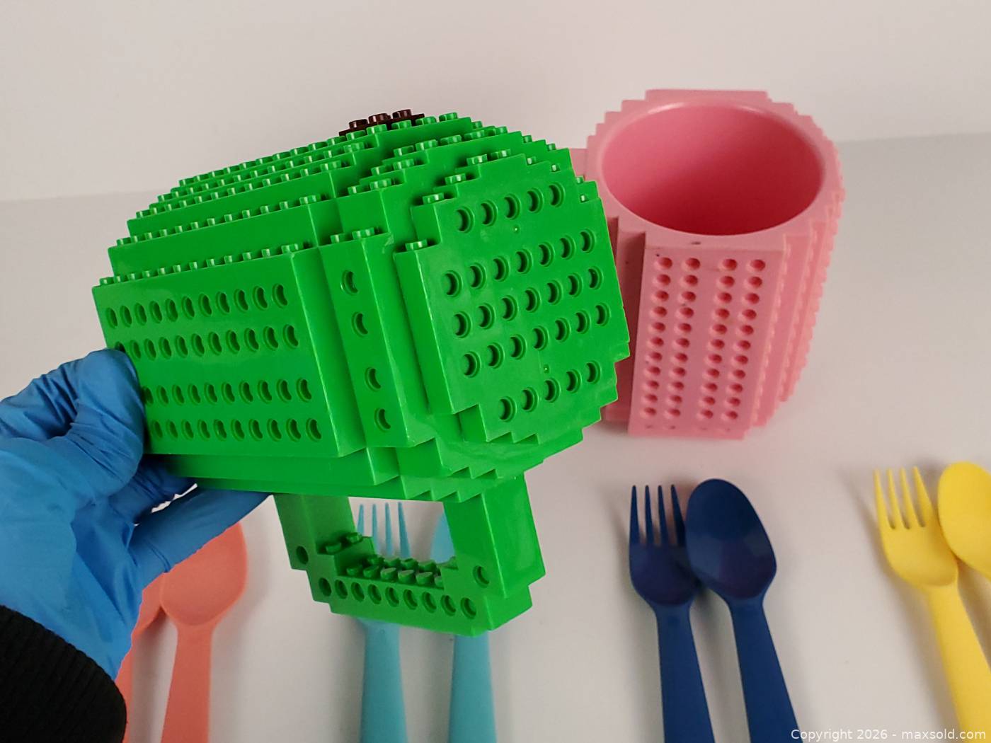 Green and pink plastic block-style mugs with eight assorted plastic ...