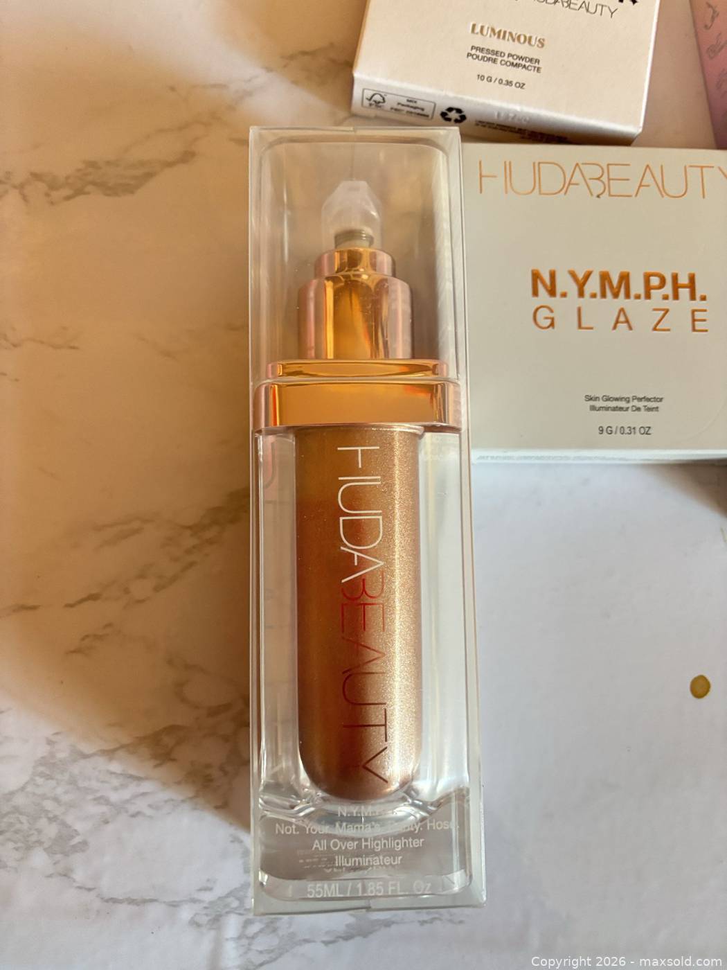 Huda Beauty Glowish powders, bronzers, N.Y.M.P.H. highlighters, brush ...