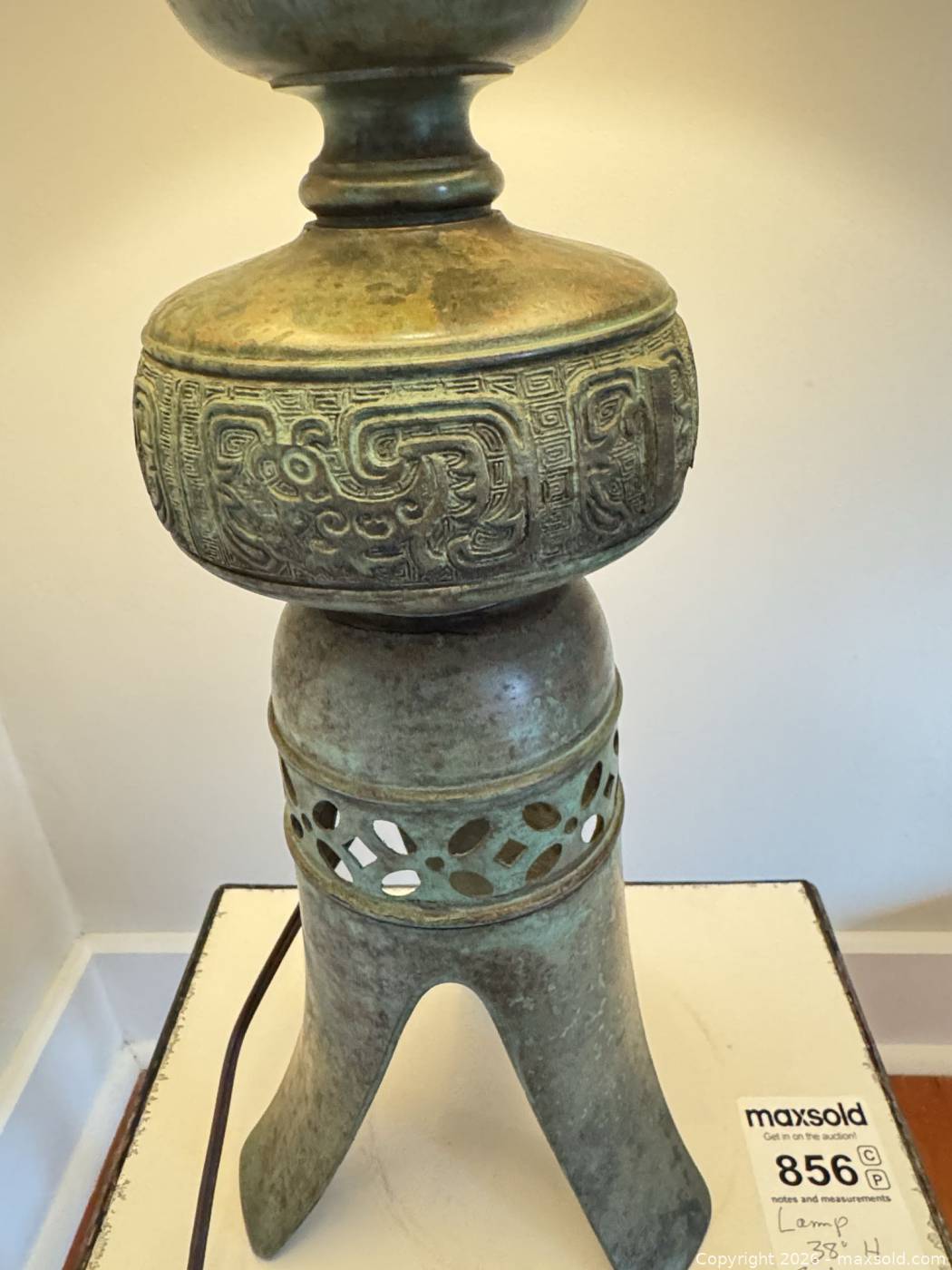 Asian-style verdigris metal table lamp and small rattan side table ...